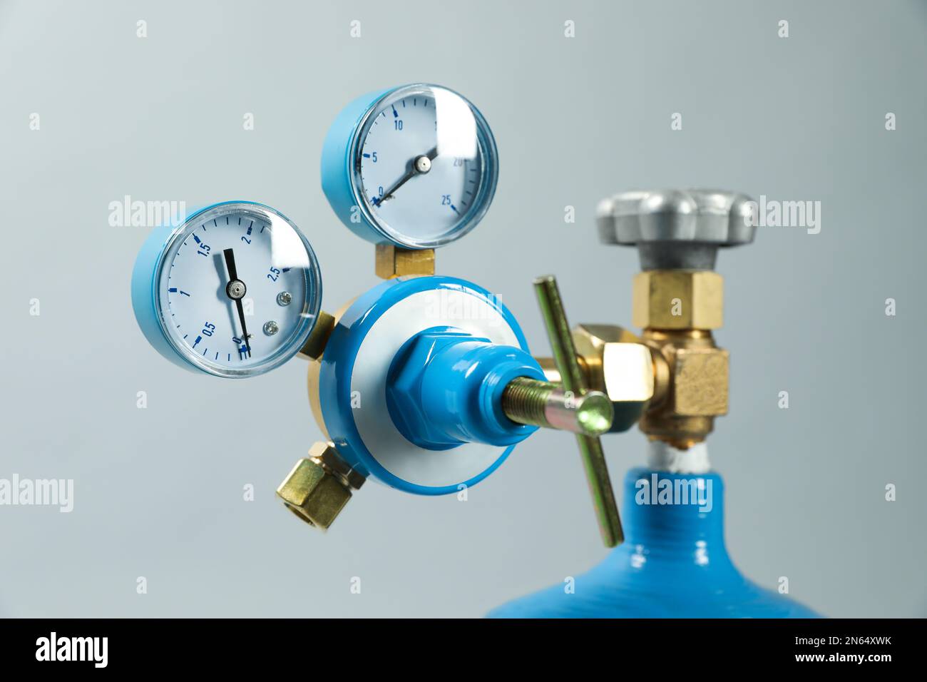 Pressure gauge of medical oxygen tank on light grey background, closeup ...