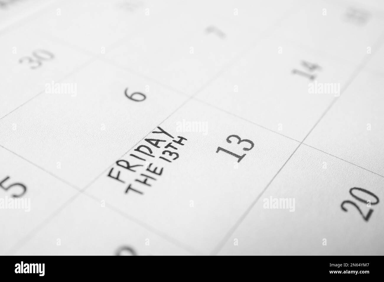 Calendar page with phrase Friday The 13th, closeup. Superstition of bad ...