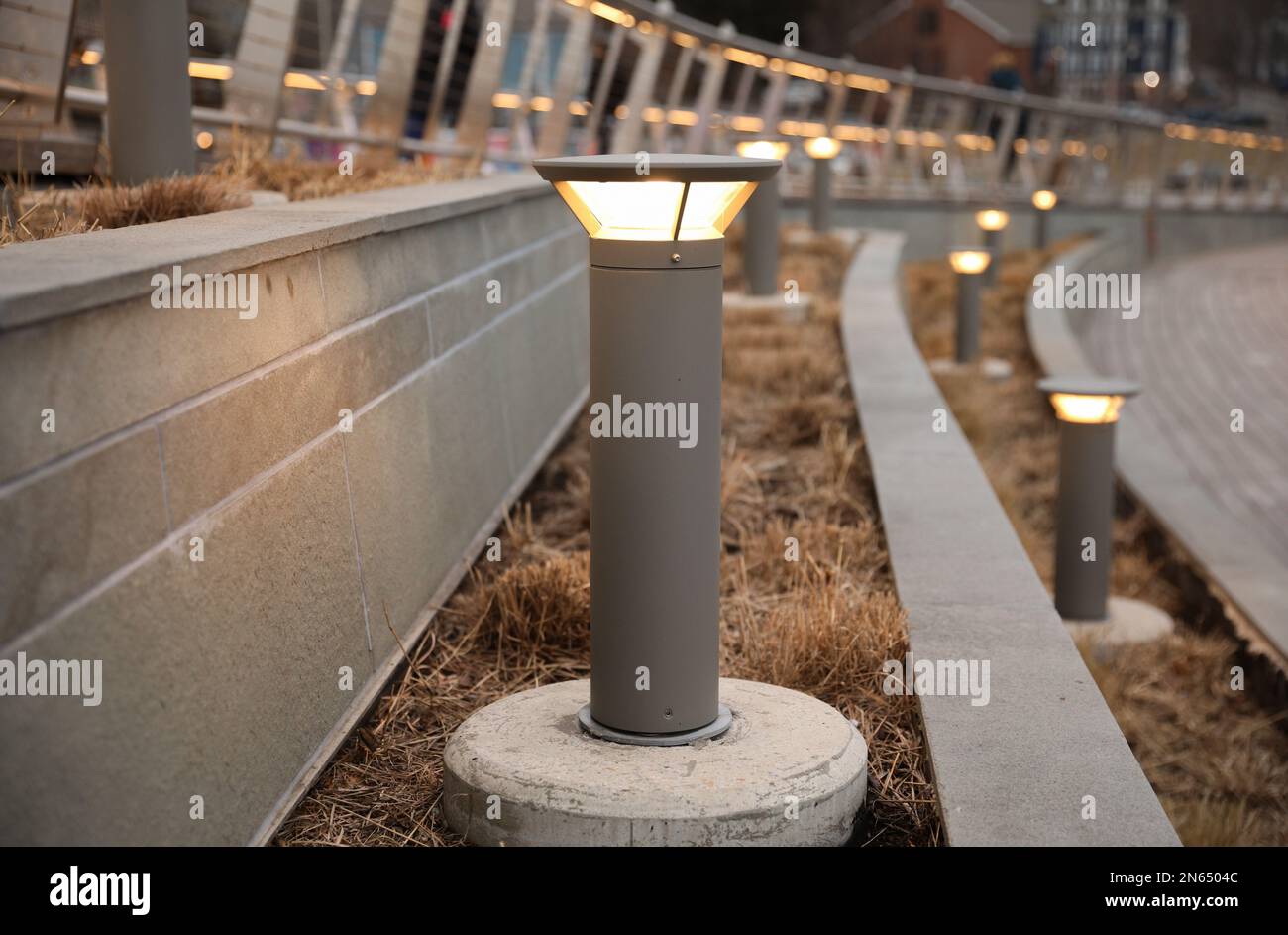 Street lamps during evening lighting up urban Stock Photo - Alamy