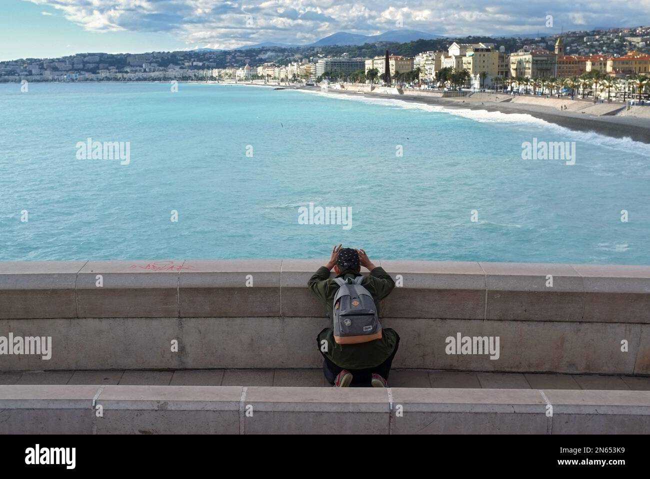 A tourist takes picture of the bay of Nice, southeastern France ...