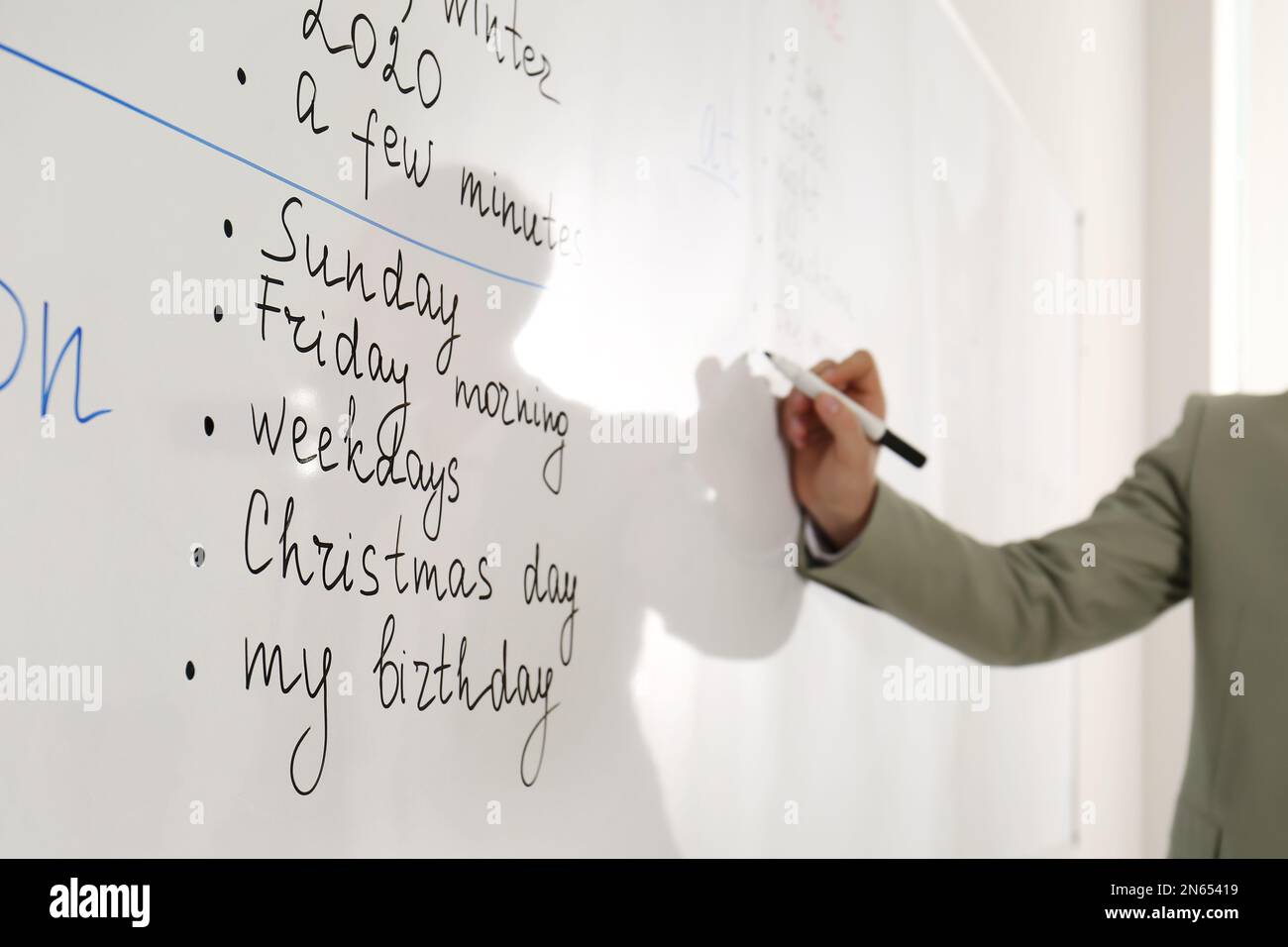 English teacher giving lesson in classroom, closeup. Focus on ...