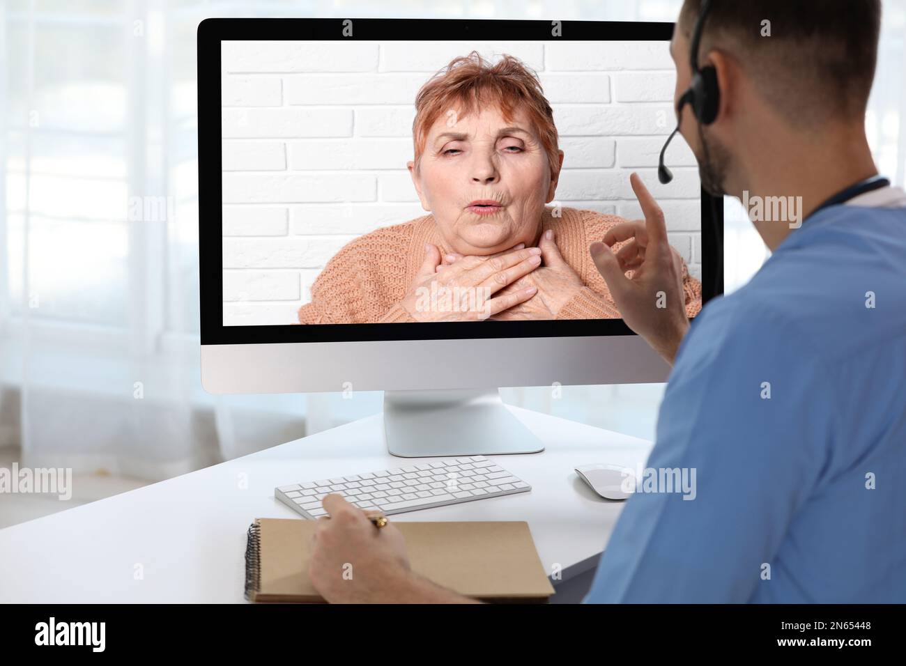 Hotline service. Doctor consulting patient online via computer indoors ...