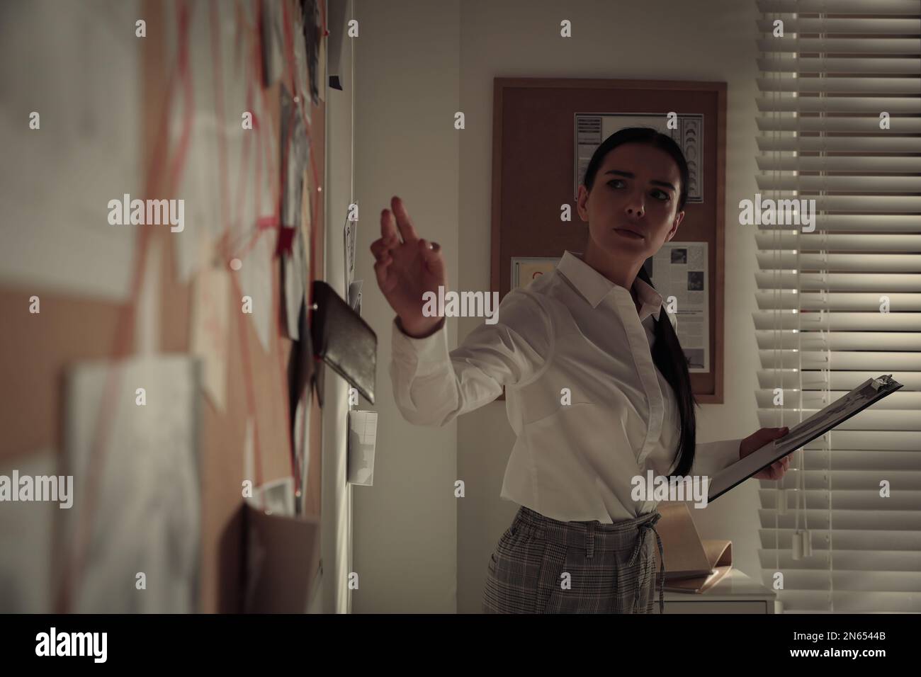 Female detective analyzing evidence hi-res stock photography and images ...