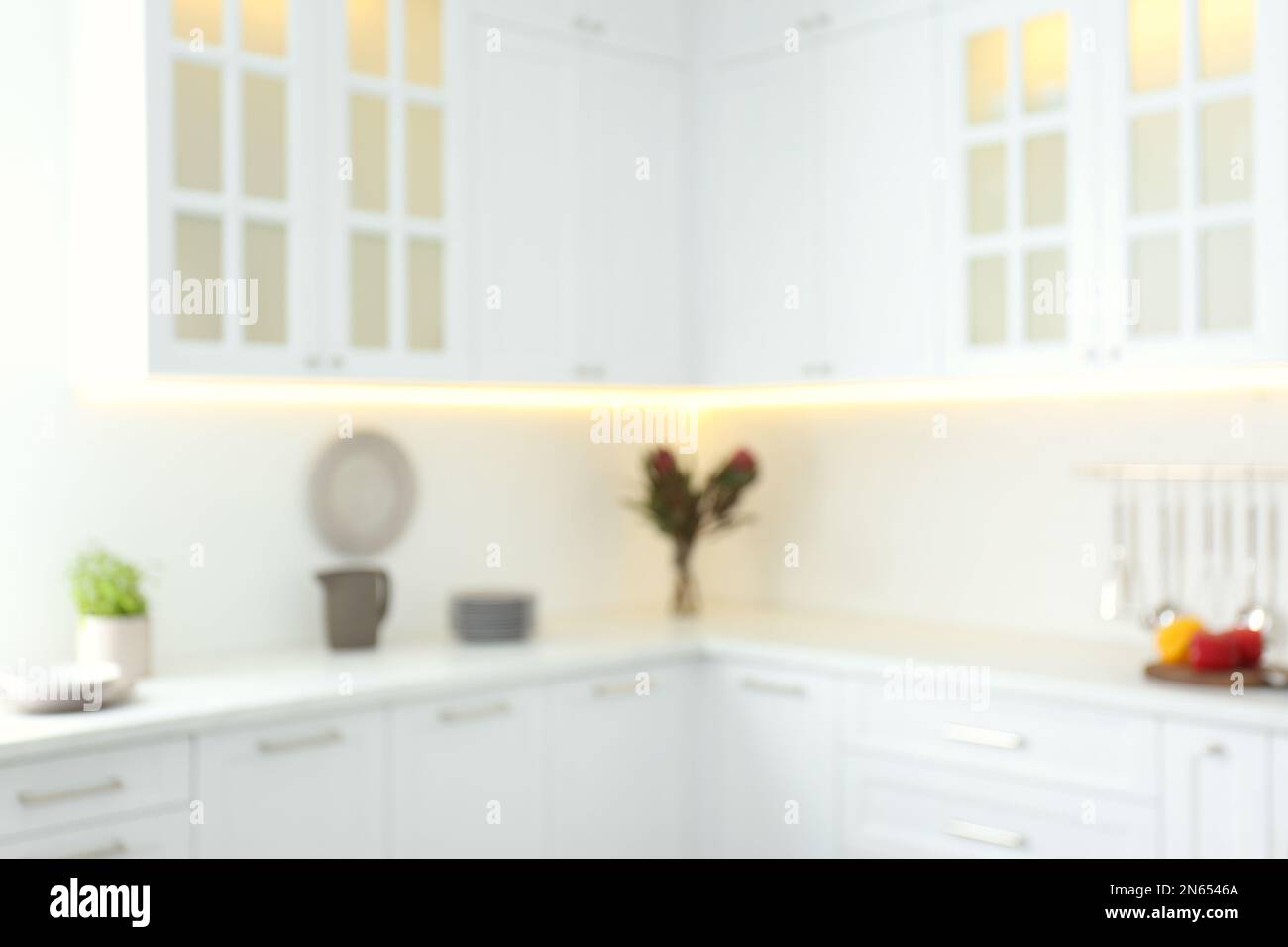 Blurred view of modern kitchen interior with white furniture Stock ...