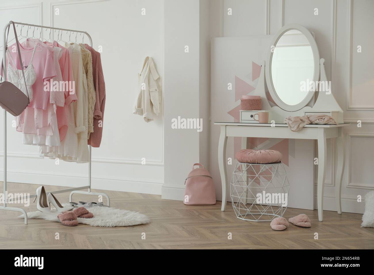 Dressing room interior with clothing rack and round mirror Stock Photo ...