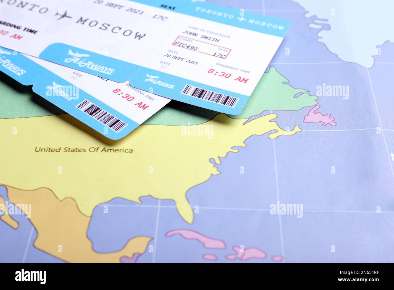 Tickets on world map, closeup. Travel agency concept Stock Photo - Alamy