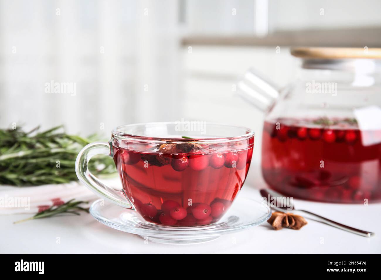 Tasty hot cranberry tea on white table Stock Photo - Alamy