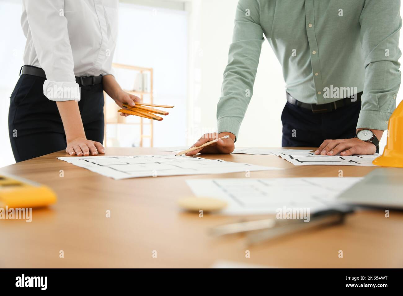 People working with construction drawings at table, closeup Stock Photo ...