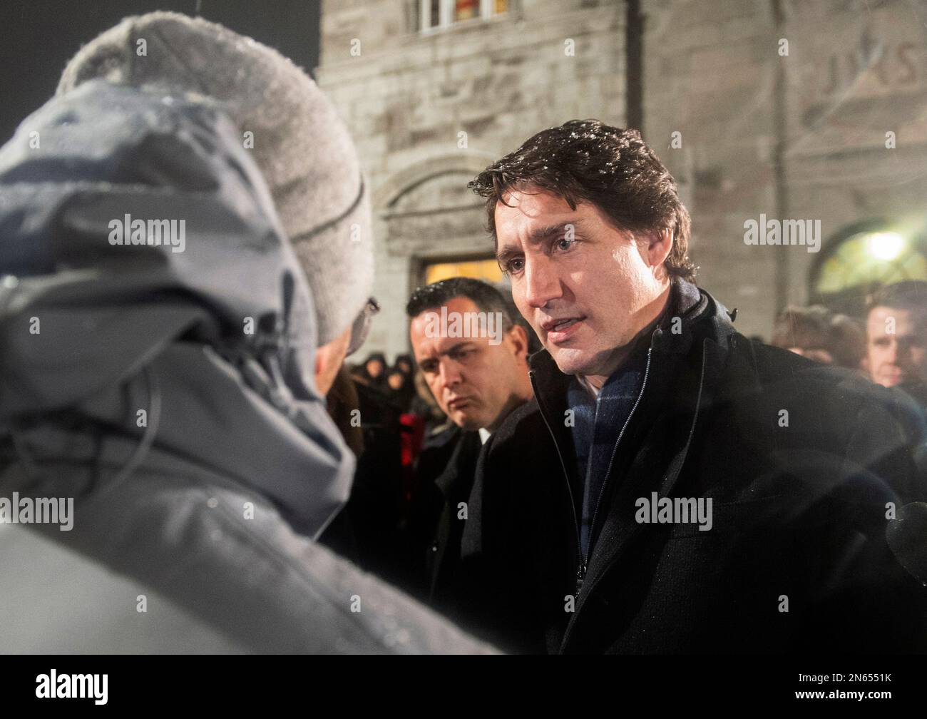 Prime Minister Justin Trudeau talks to a man as he attends a vigil at a ...