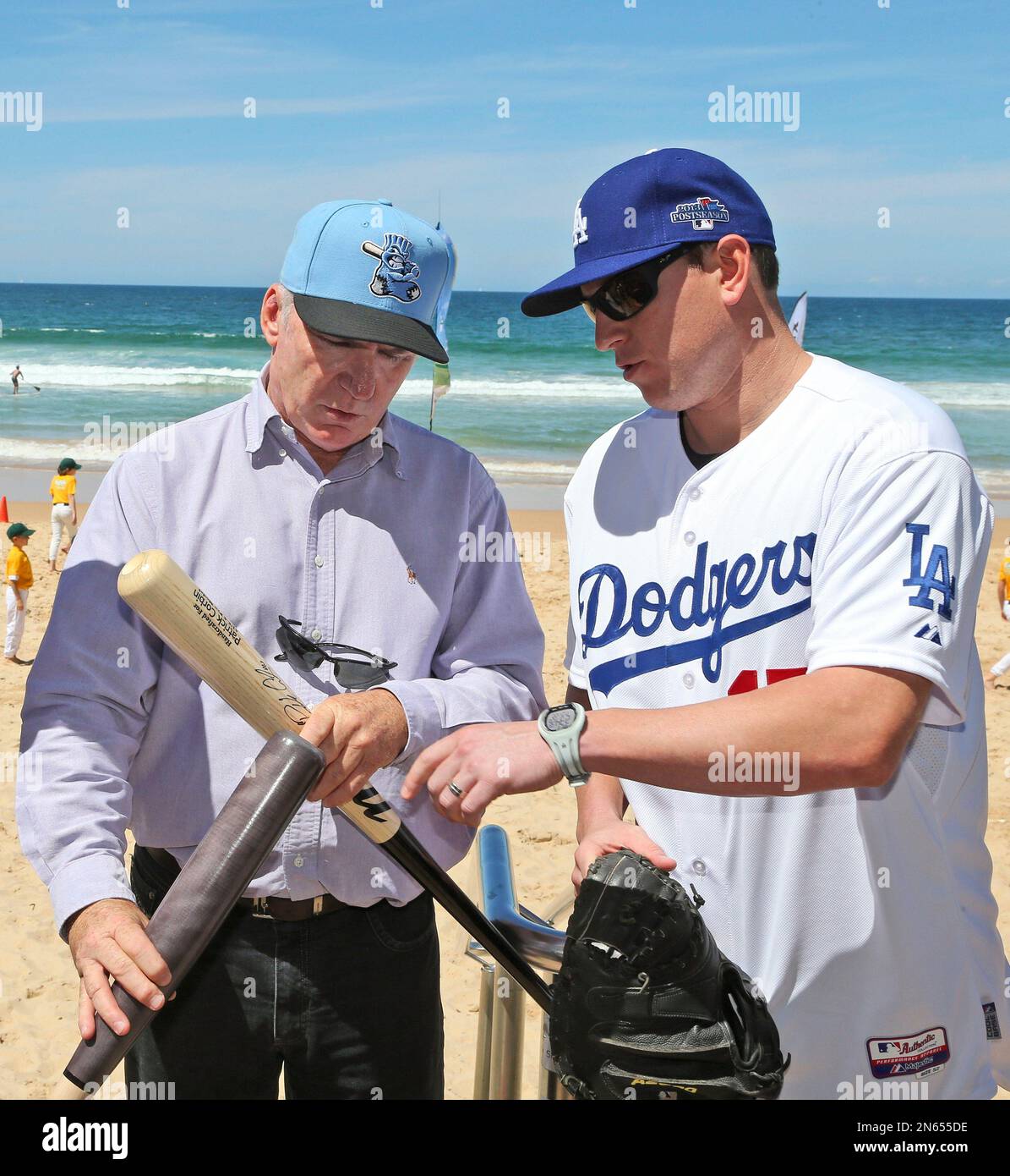 Former Australian cricket captain Allan Border, left, checks a bat with ...