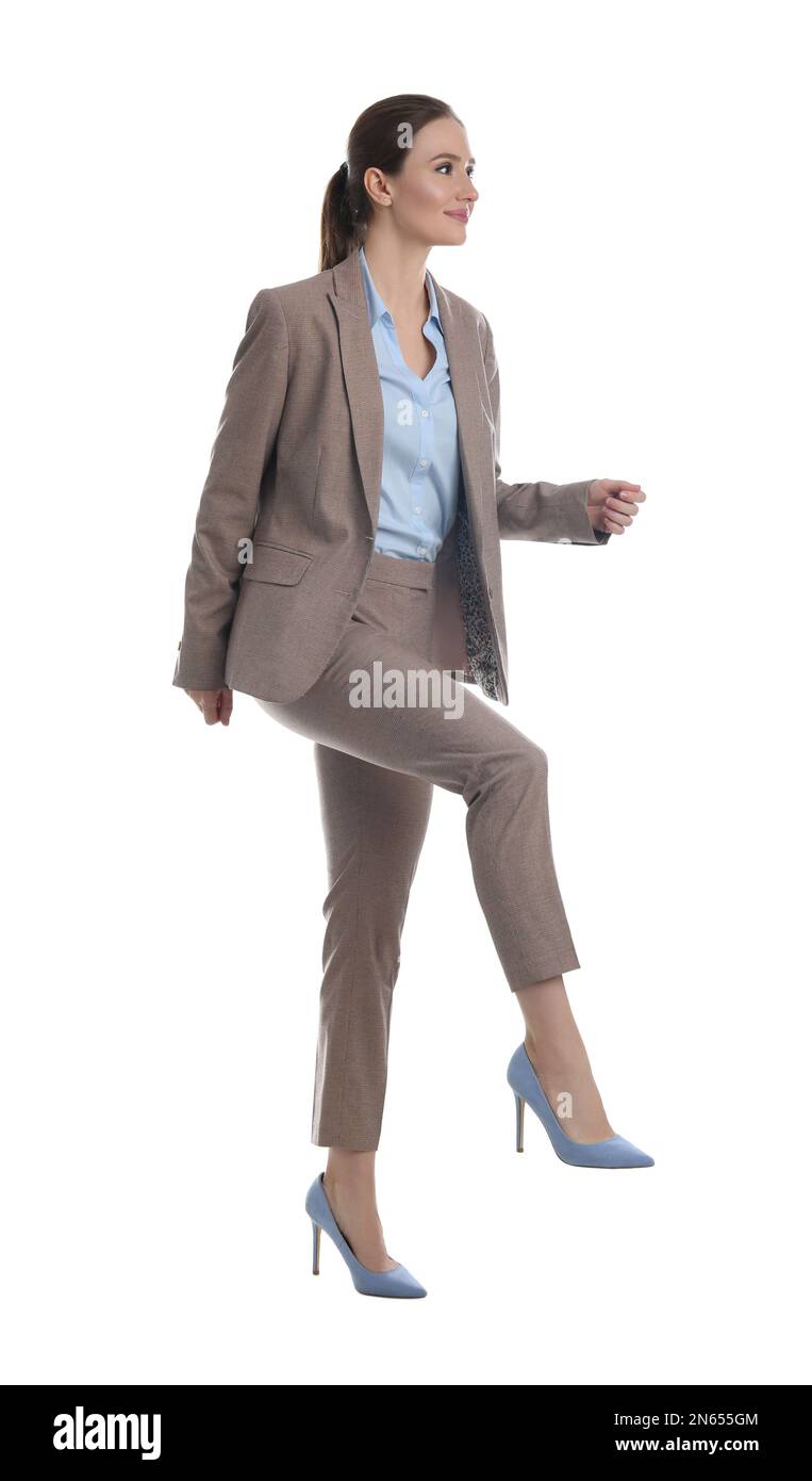 Businesswoman imitating stepping up on stairs against white background ...