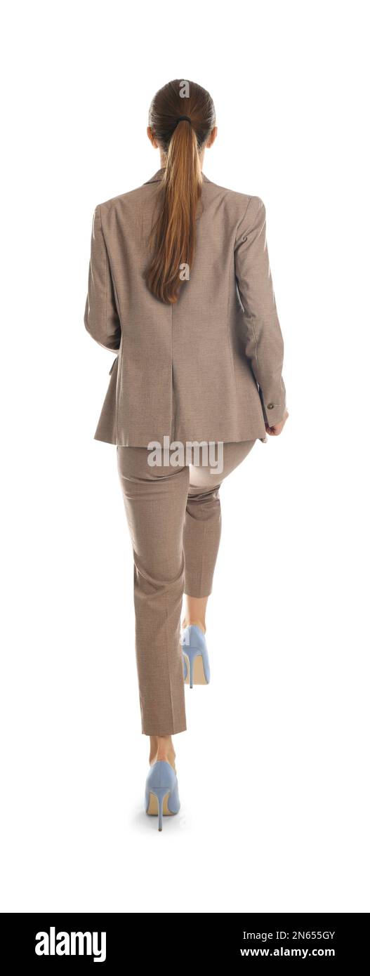 Businesswoman imitating stepping up on stairs against white background ...