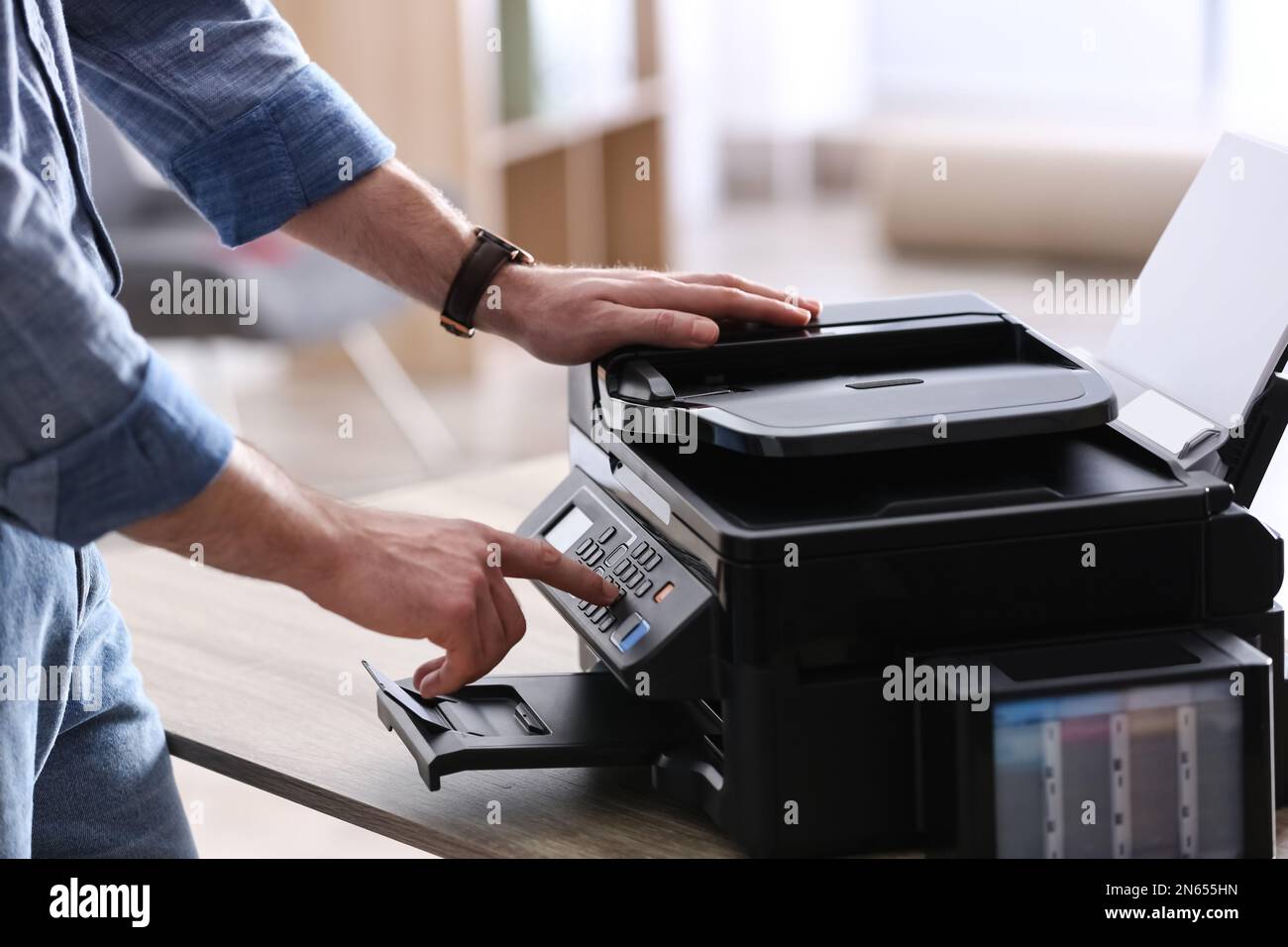 Employee using modern printer in office, closeup Stock Photo - Alamy