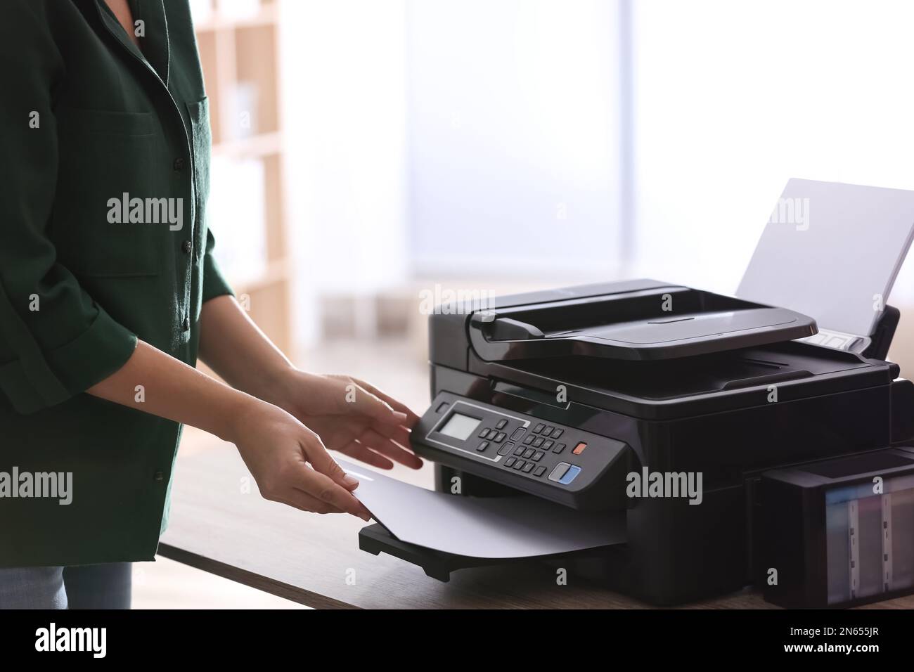 Employee using modern printer in office, closeup Stock Photo - Alamy