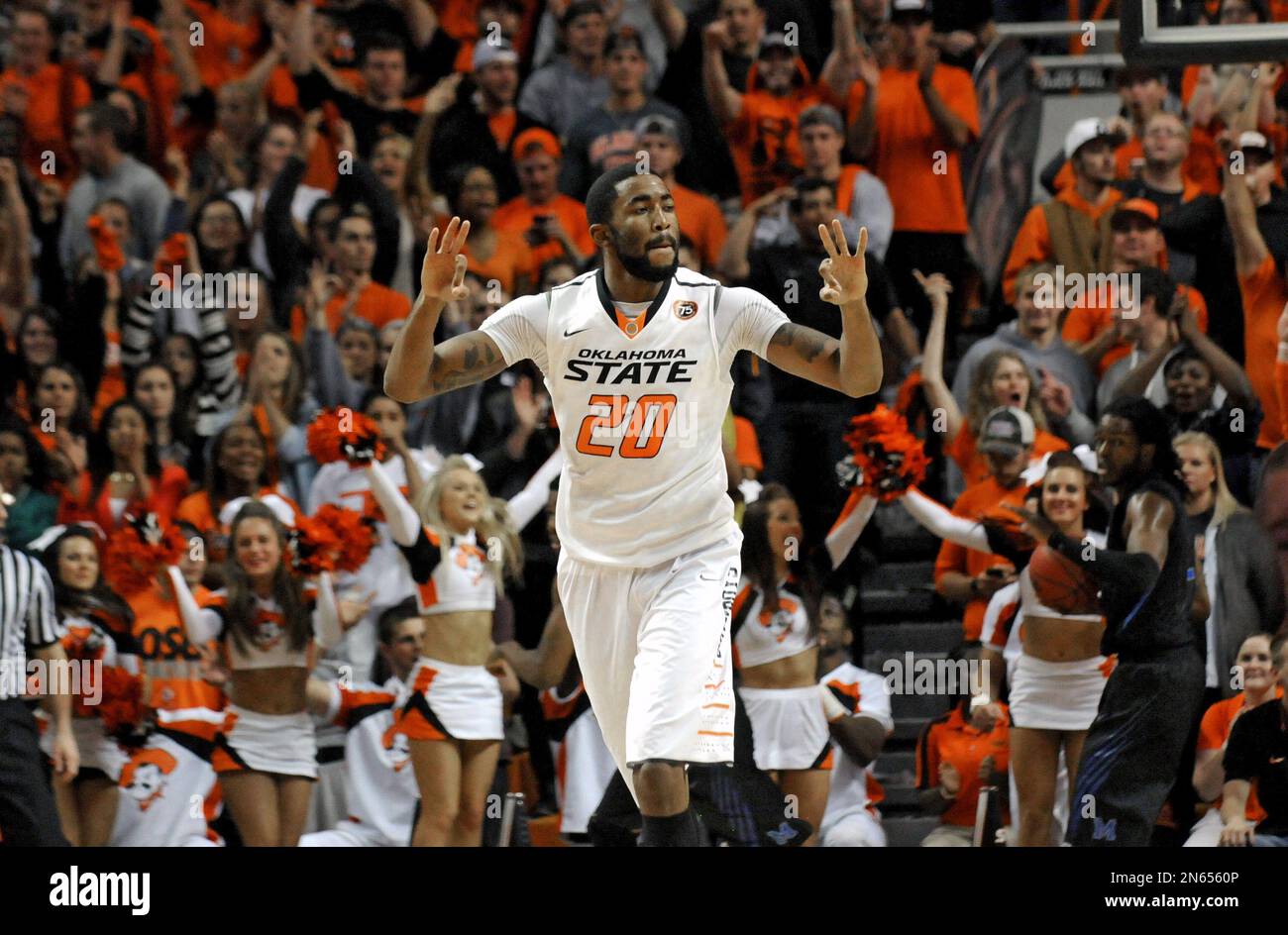 Oklahoma State post Michael Cobbins signals a 3 point score, following ...