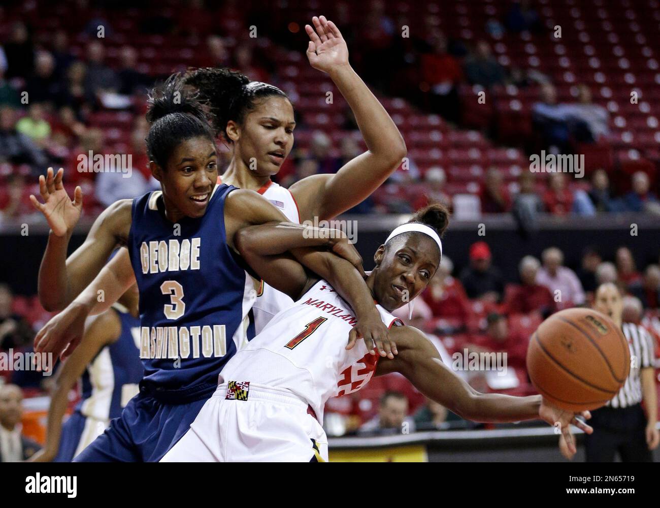 Maryland guard Laurin Mincy (1) gets tangled with George Washington ...