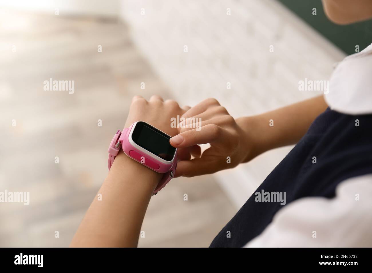 Girl using stylish smart watch in classroom, closeup Stock Photo - Alamy