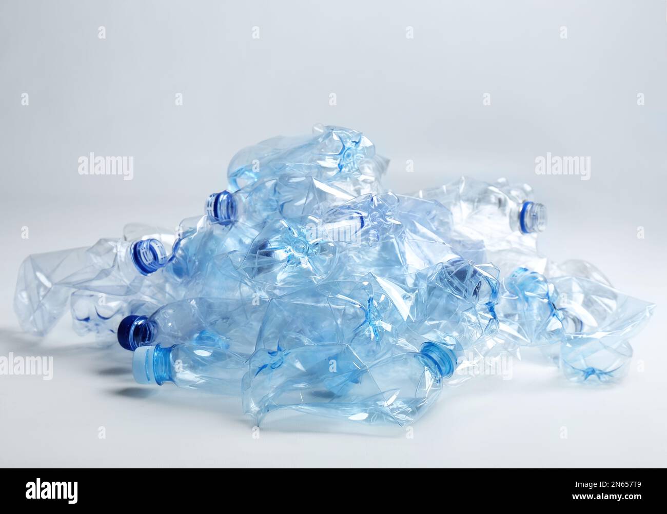 Heap of used plastic bottles on white background. Recycling problem ...