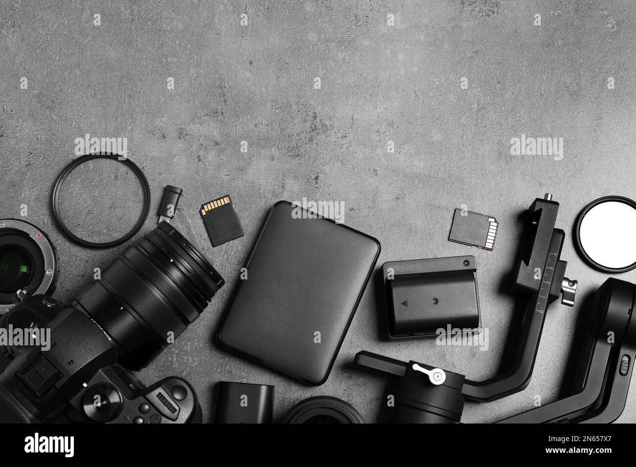 Camera and video production equipment on grey stone background, flat ...