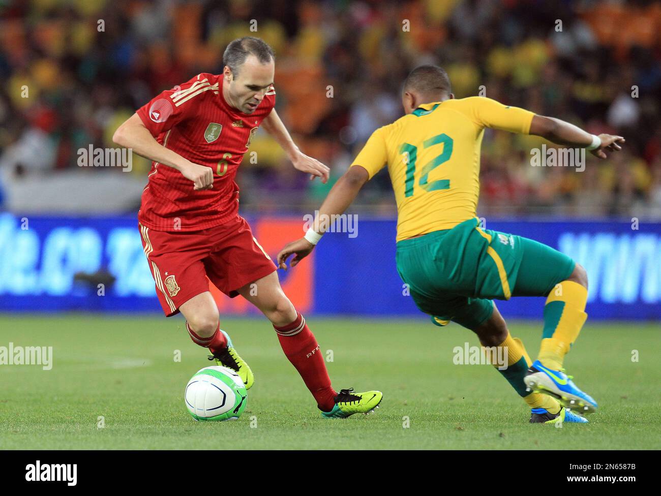 Spain's Andres Iniesta, left, is challenged by South Africa's Andile ...