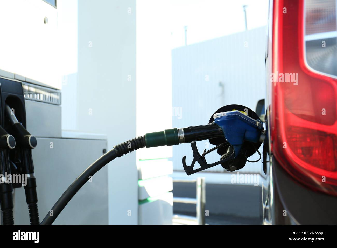 Modern car refilling with fuel at gas station Stock Photo - Alamy