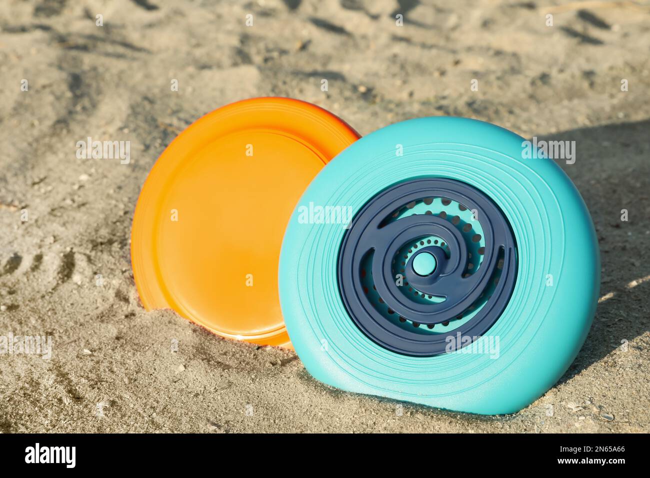 New plastic frisbee discs on sandy beach, closeup Stock Photo - Alamy