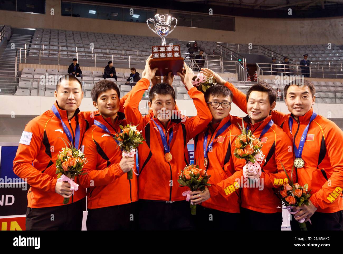 Chinese men's curling team pose with their champion trophy during the ...