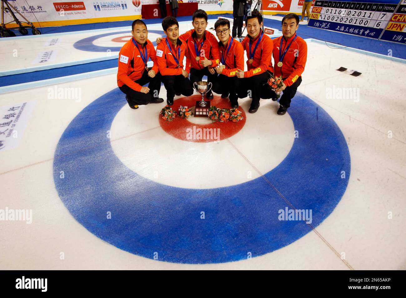 Chinese men's curling team pose with their champion trophy during the ...