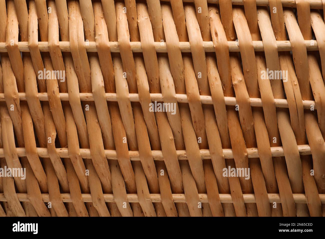 Handmade wicker basket made of natural material as background, closeup ...