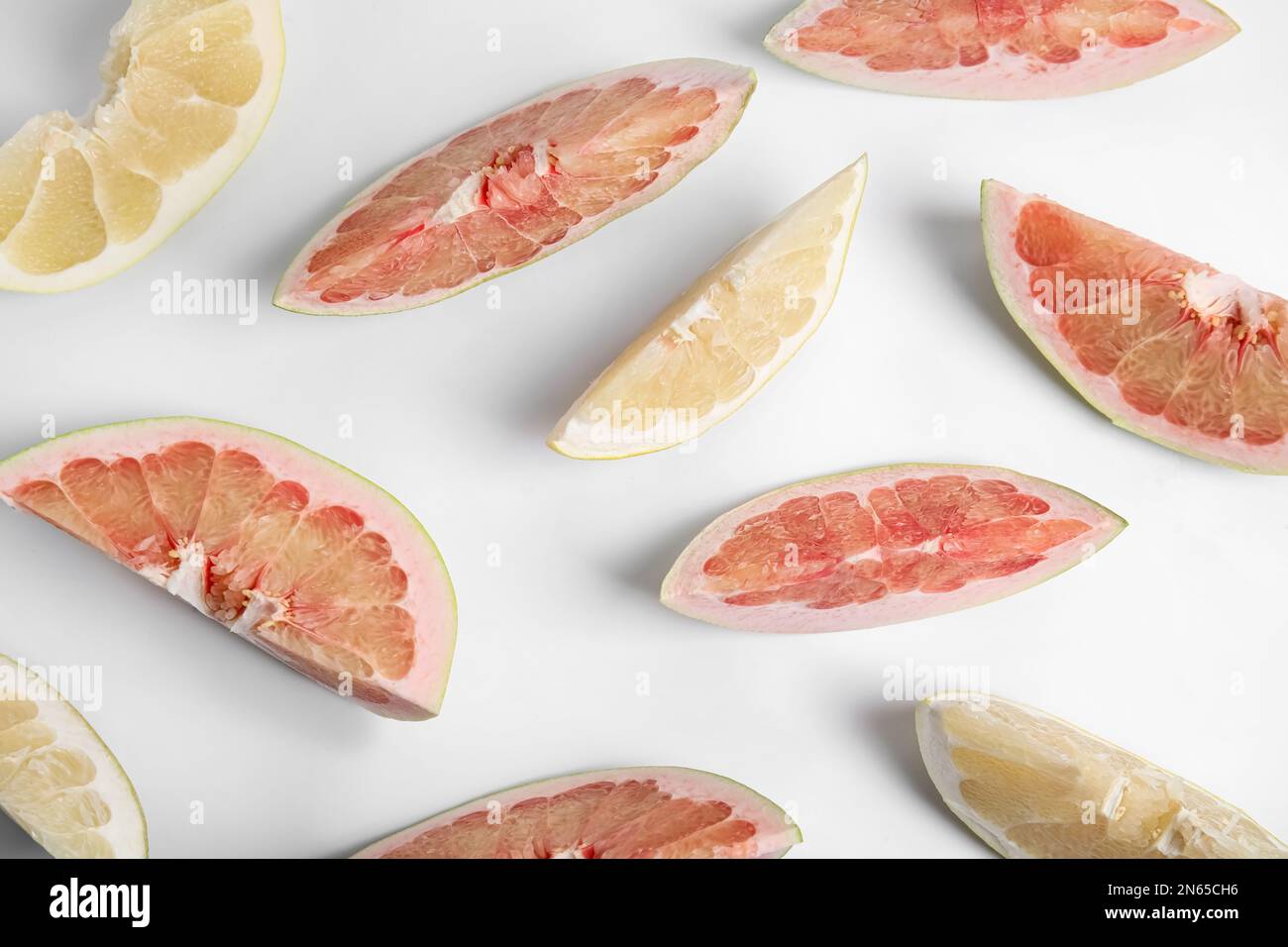 Slices of different ripe pomelos on white background, flat lay Stock ...