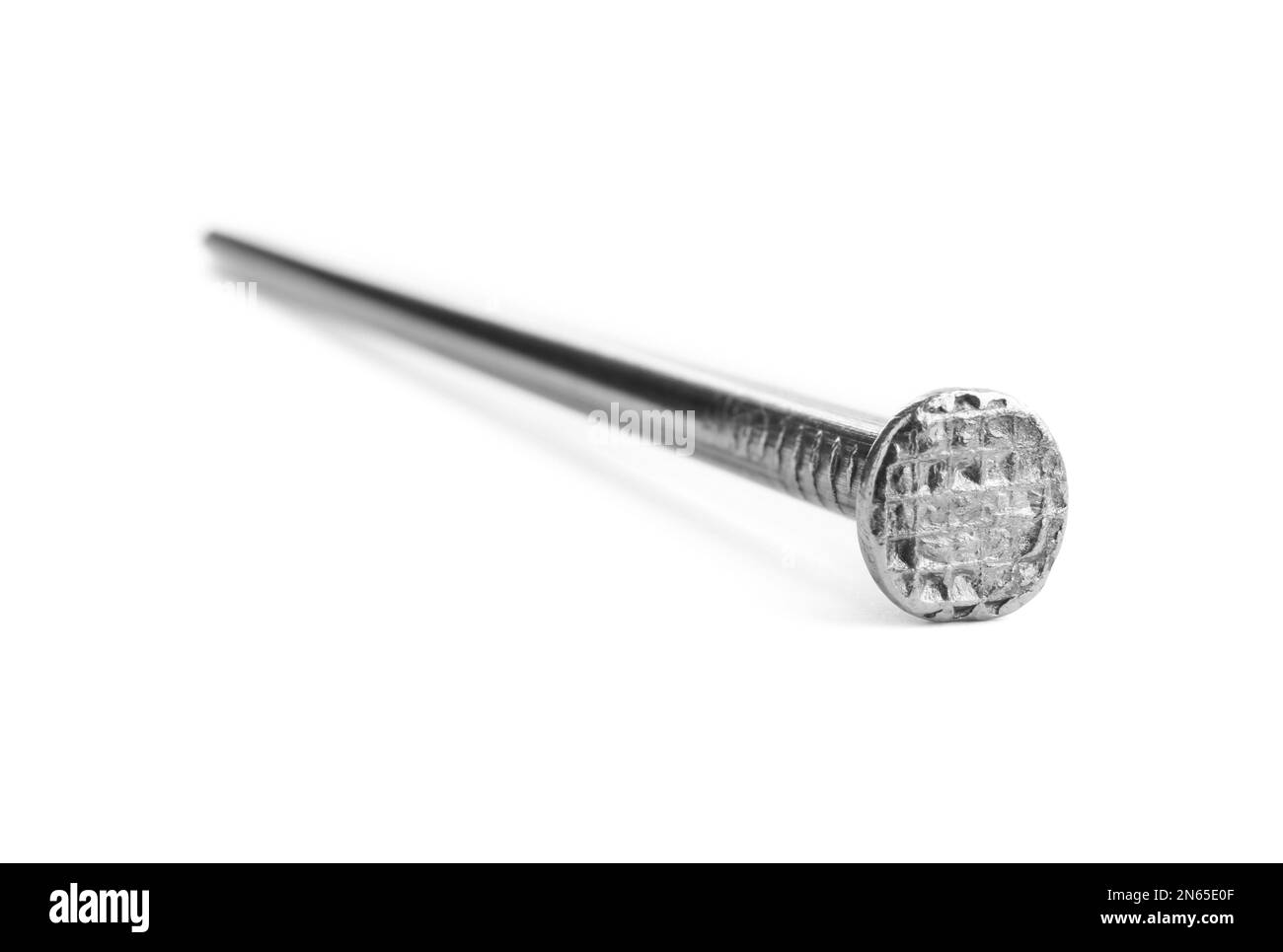 One shiny metal nail isolated on white Stock Photo - Alamy