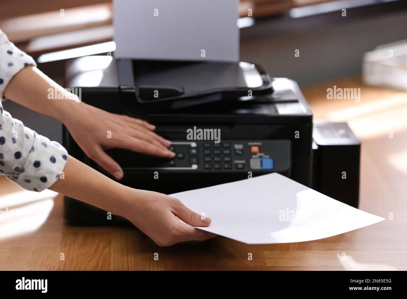 Employee using modern printer in office, closeup Stock Photo - Alamy