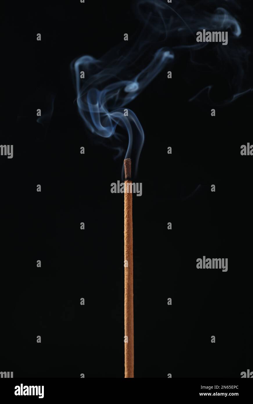 Incense stick smoldering on black background, closeup Stock Photo - Alamy