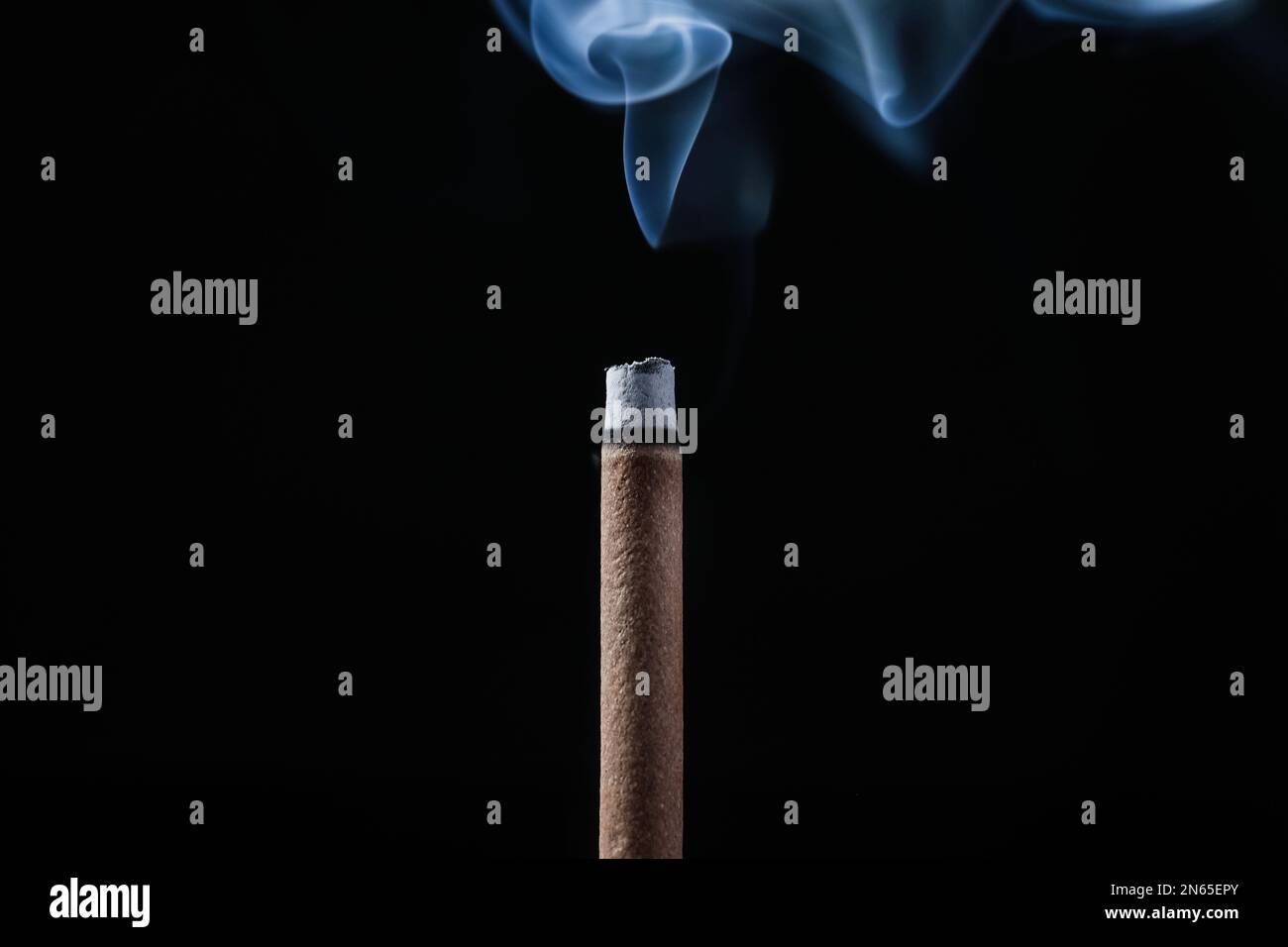 Incense stick smoldering on black background, closeup Stock Photo - Alamy
