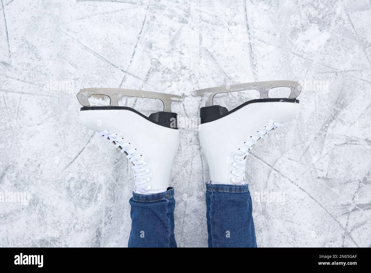Woman wearing figure skates on ice rink, top view Stock Photo - Alamy
