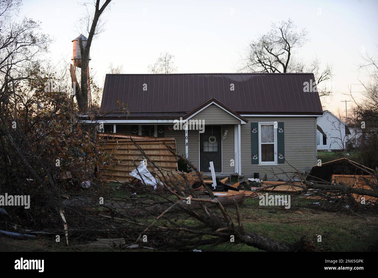 Debris lies on the ground in front of a home in Brookport, Ill., Monday ...