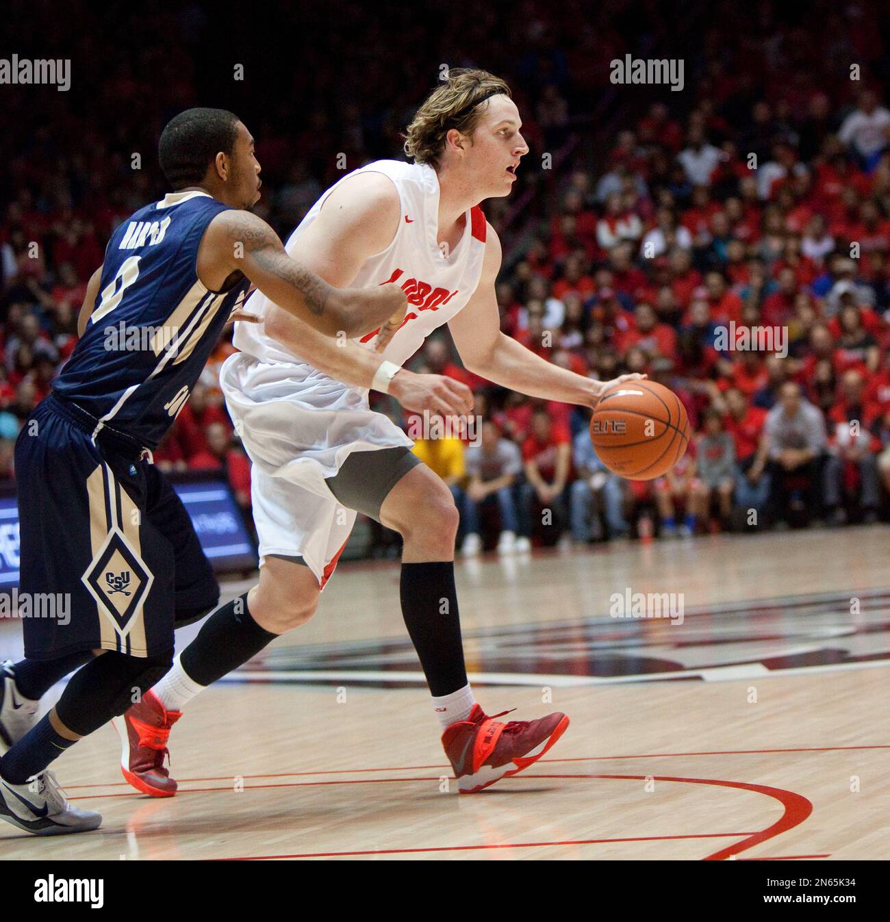 New Mexico's Cameron Bairstow, right, looks to pass the ball as ...