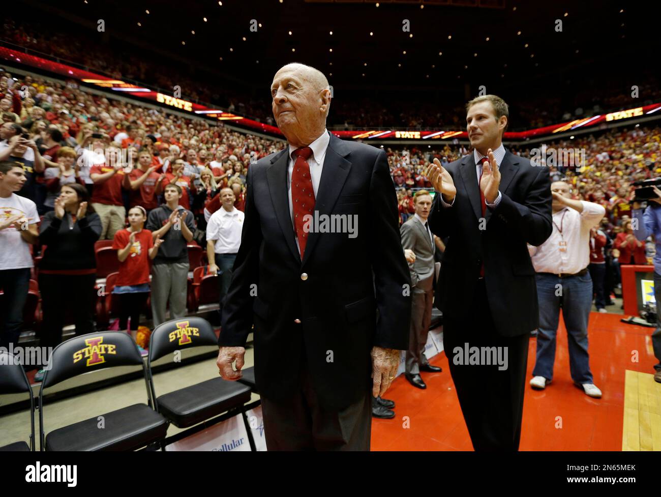 Former Iowa State basketball coach Johnny Orr, left, walks onto the ...