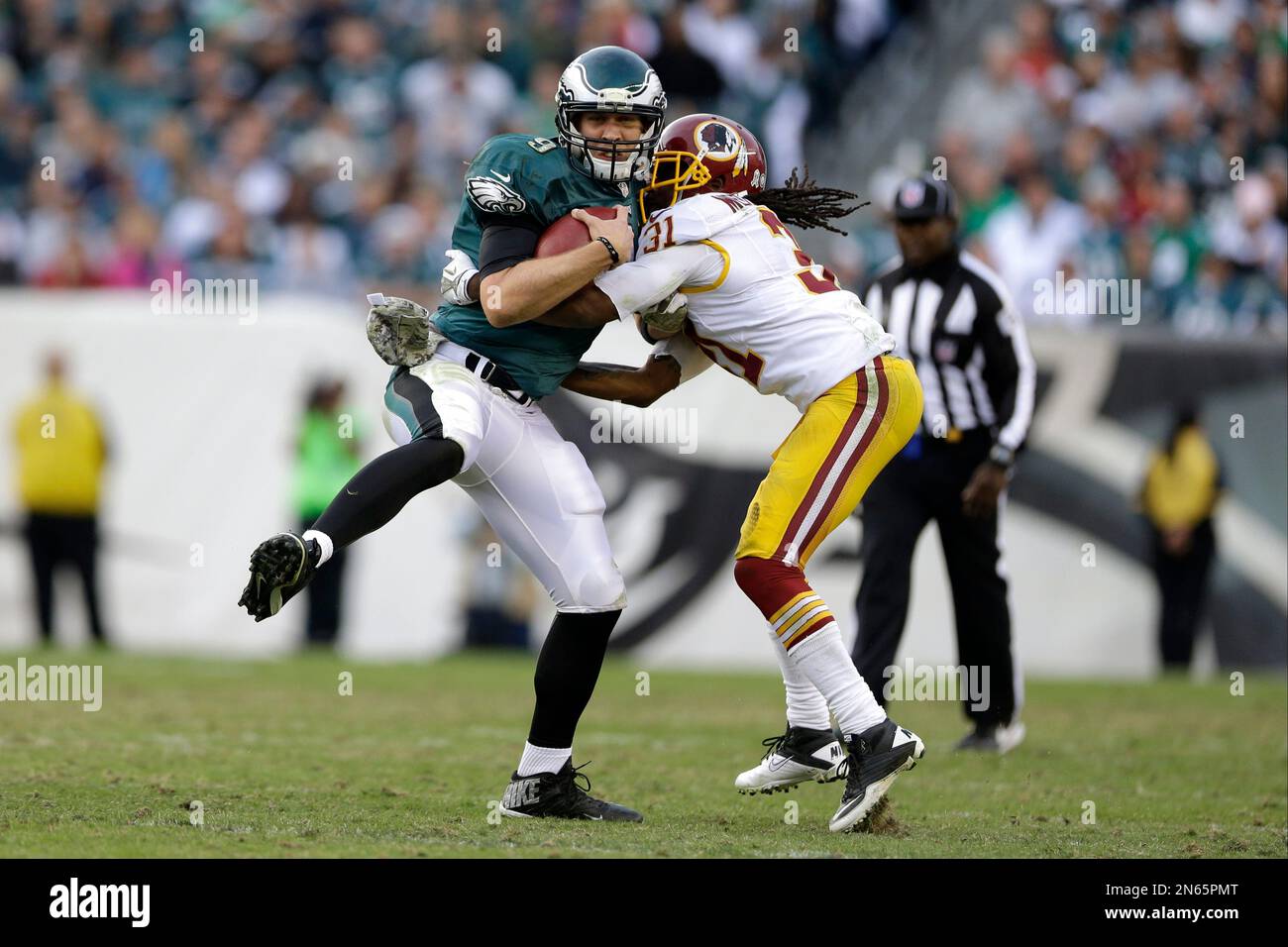 Philadelphia Eagles quarterback Nick Foles is spun around by Washington ...