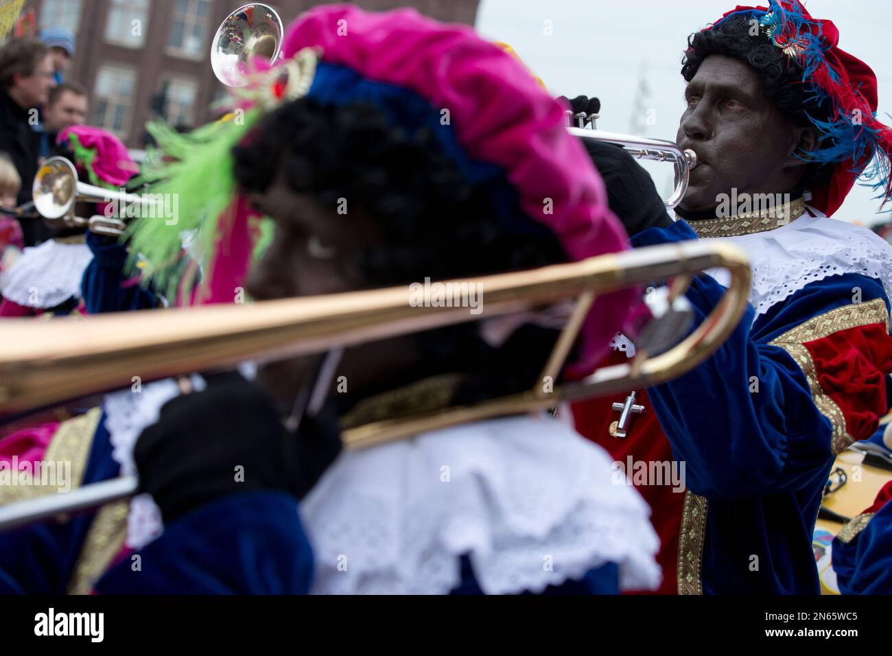 Men dressed as 'Zwarte Piet' or Black Pete, perform as spectators watch ...