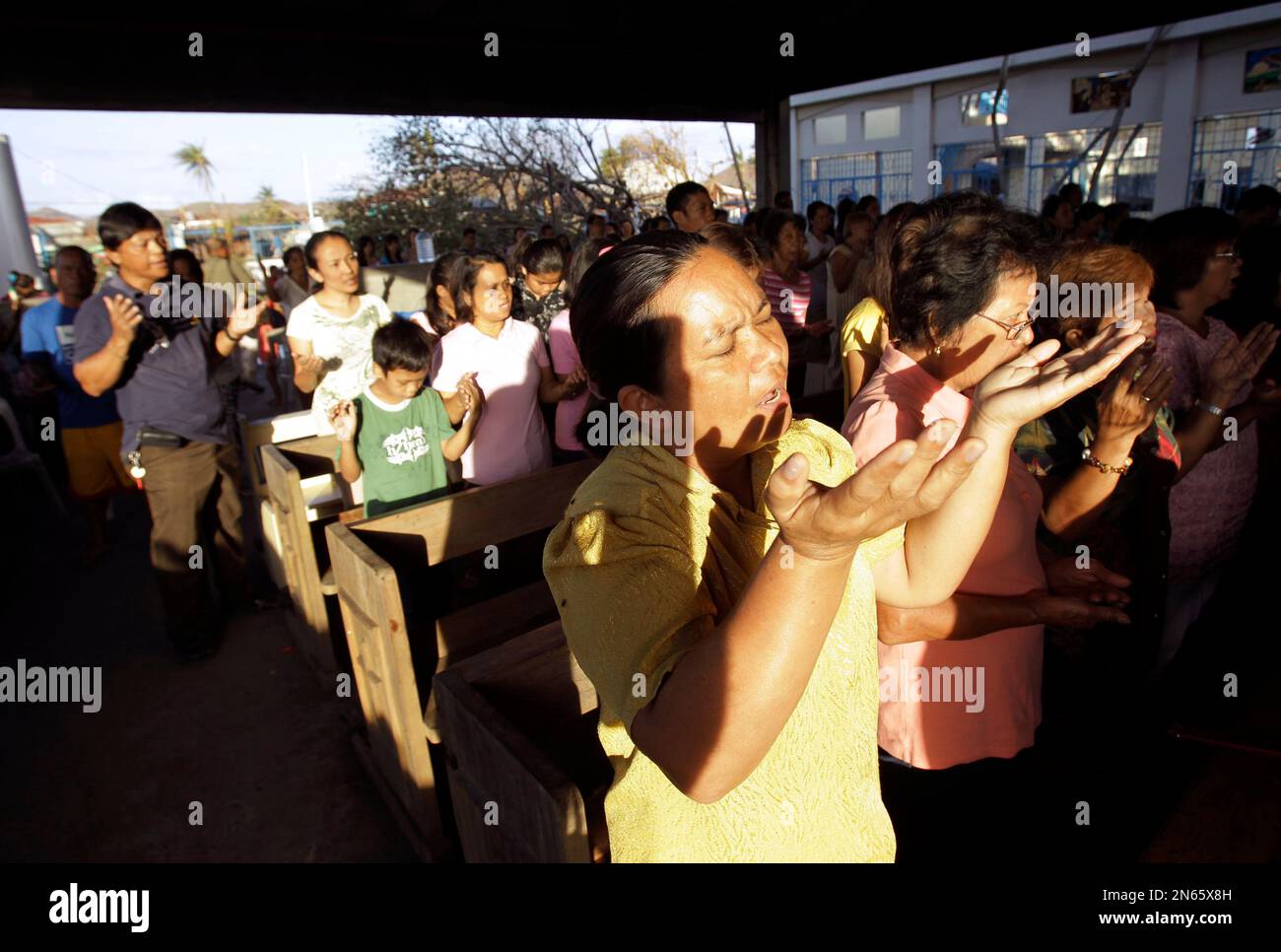 CORRECTS NAME OF CHURCH - Typhoon survivors pray during a church ...
