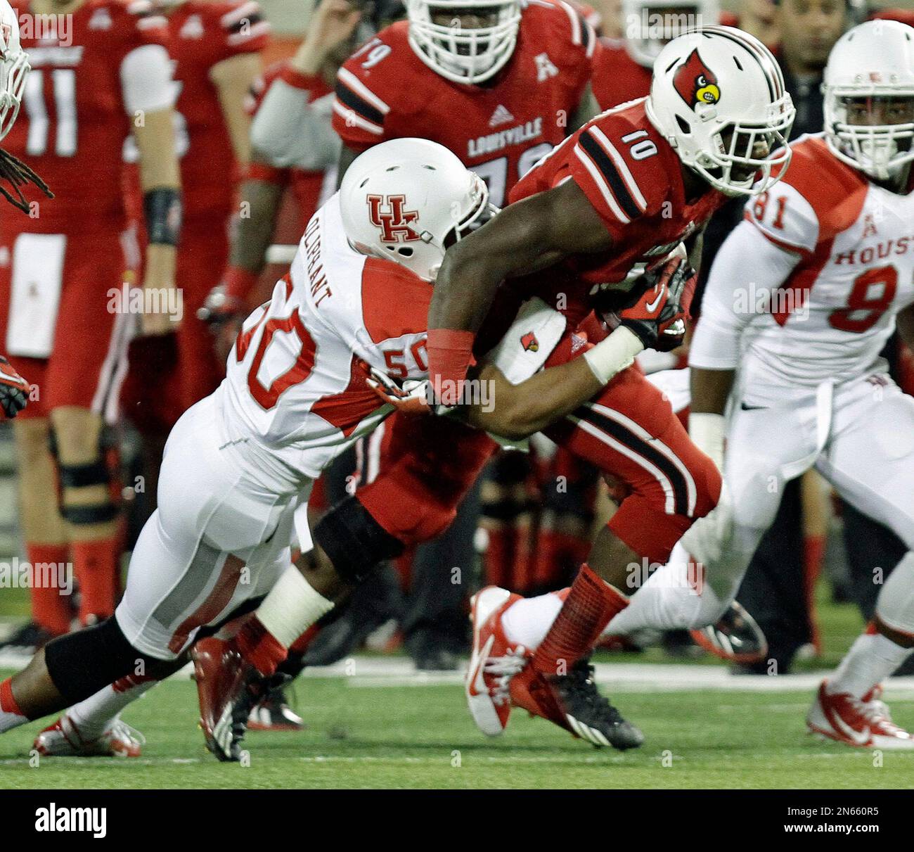 Louisville running back Dominique Brown (10) tries to break free of ...