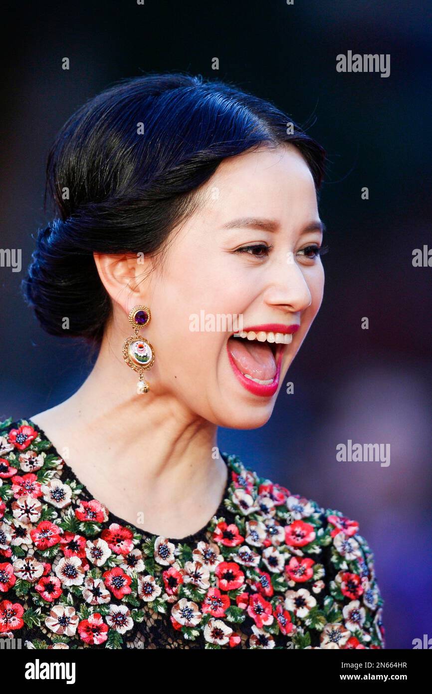 Actress Ni Hongjie poses for photographers as she arrives for the ...