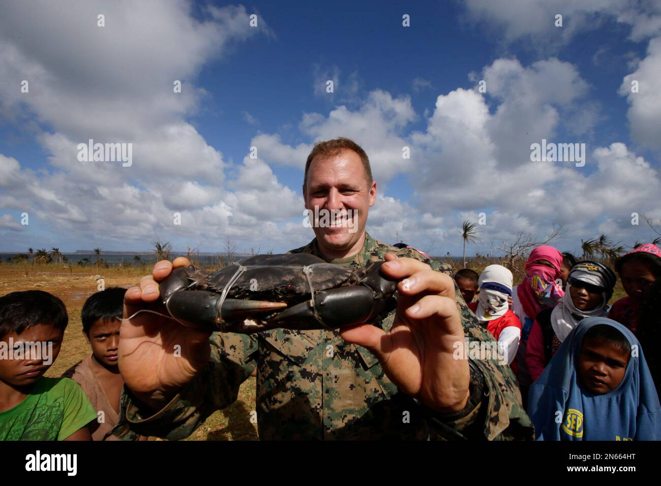 US Marine Maj. John Orio shows a crab given to him by a resident in ...