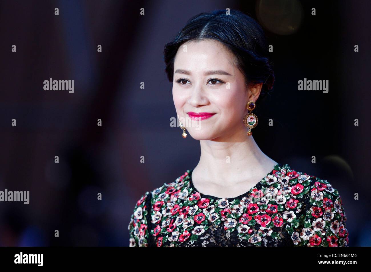 Actress Ni Hongjie poses for photographers as she arrives for the ...