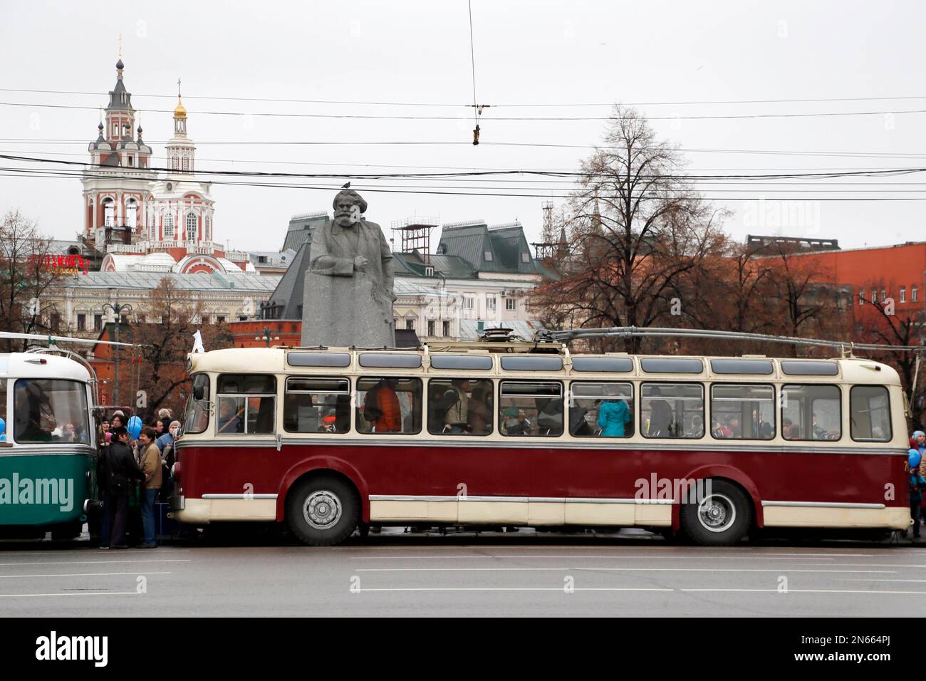 Visitors go inside old trolleybuses standing at the square near the ...