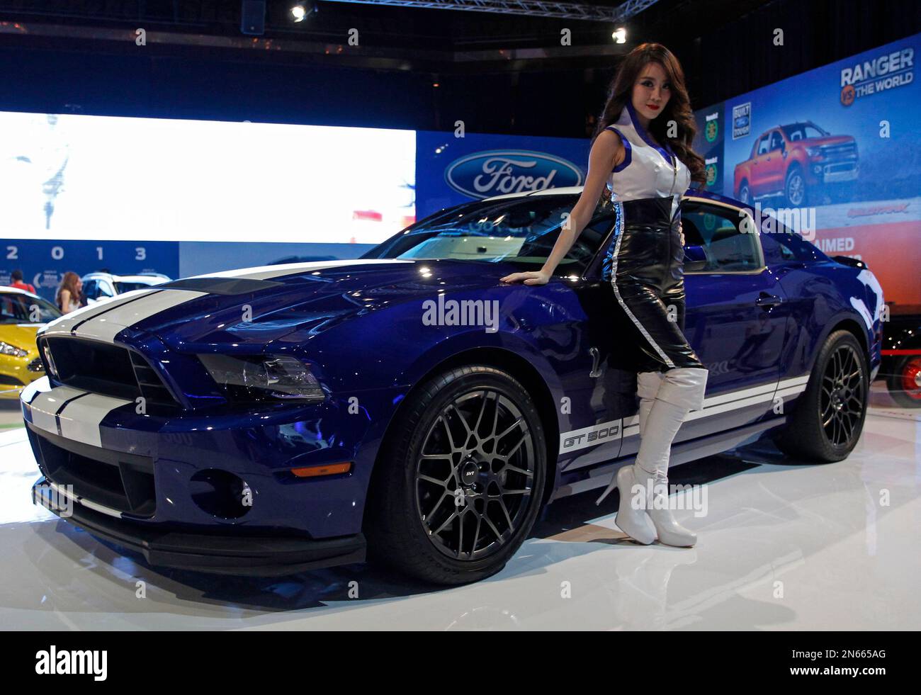 A model poses next to a Ford Mustang Shelby GT500 on display at the ...