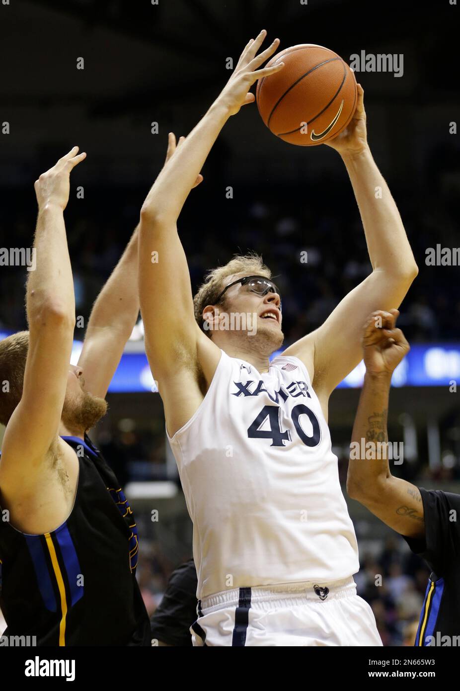 Xavier center Matt Stainbrook pulls in a rebound against Morehead State ...