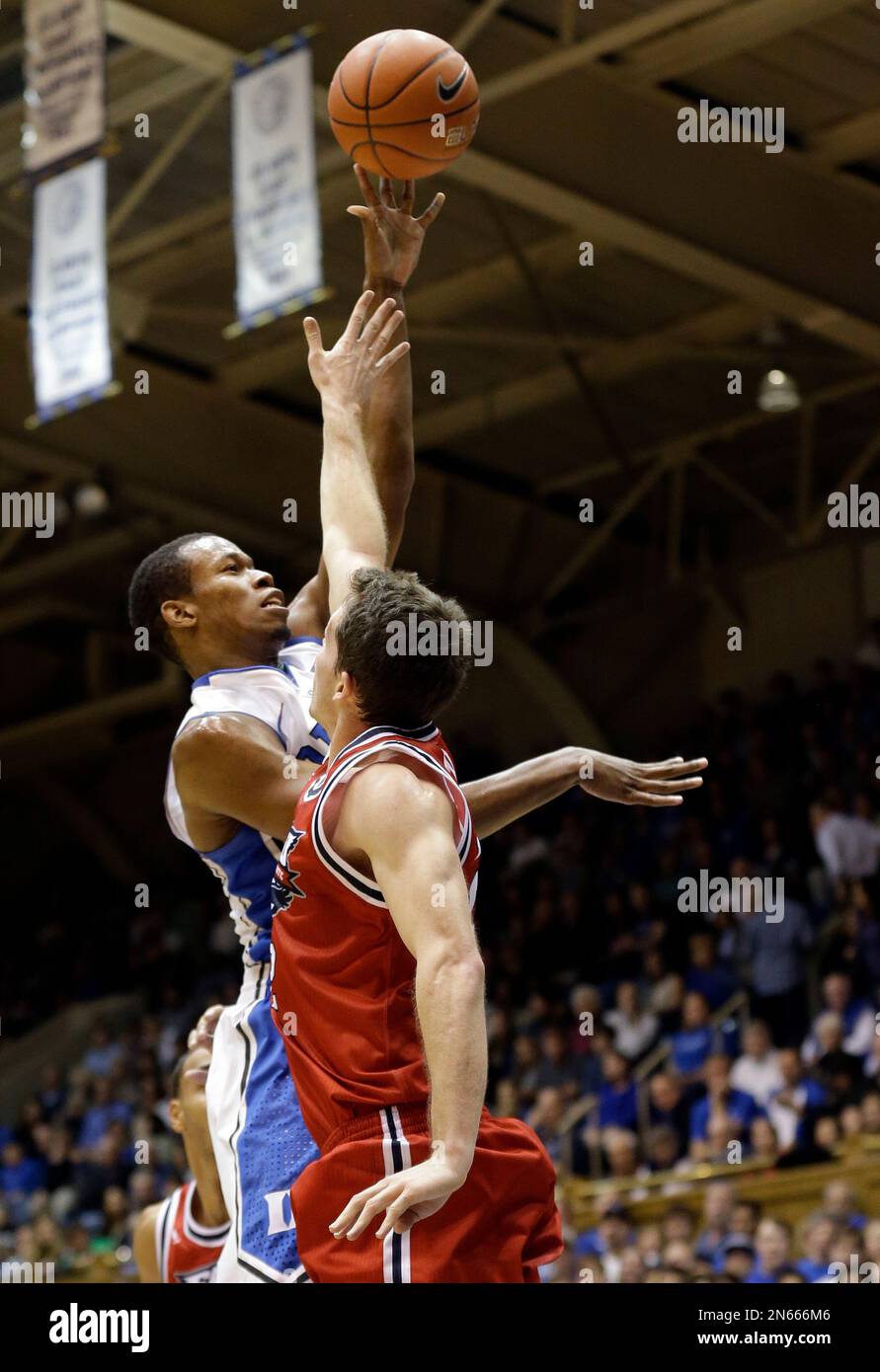 Duke's Rodney Hood, left, shoots over Florida Atlantic's Jackson Trapp ...