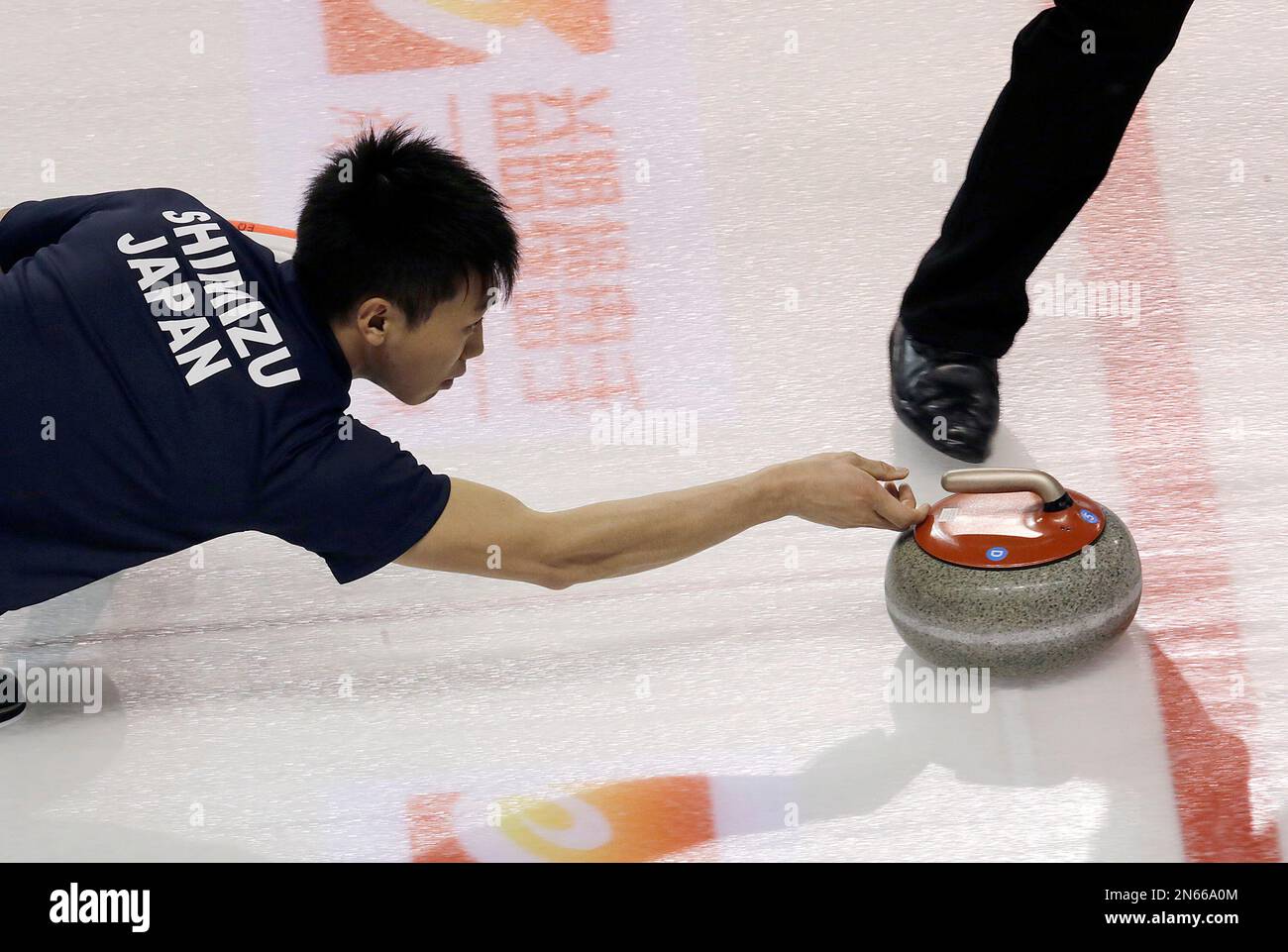 Japan's Tetsuro Shimizu releases the stone during a match against ...